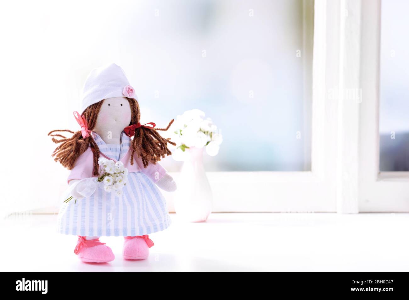 Handmade doll near window close-up Stock Photo - Alamy