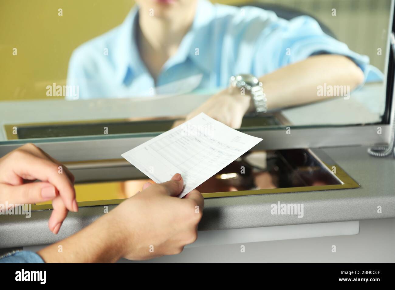 Teller window with working cashier. Concept of payment of utilities ...