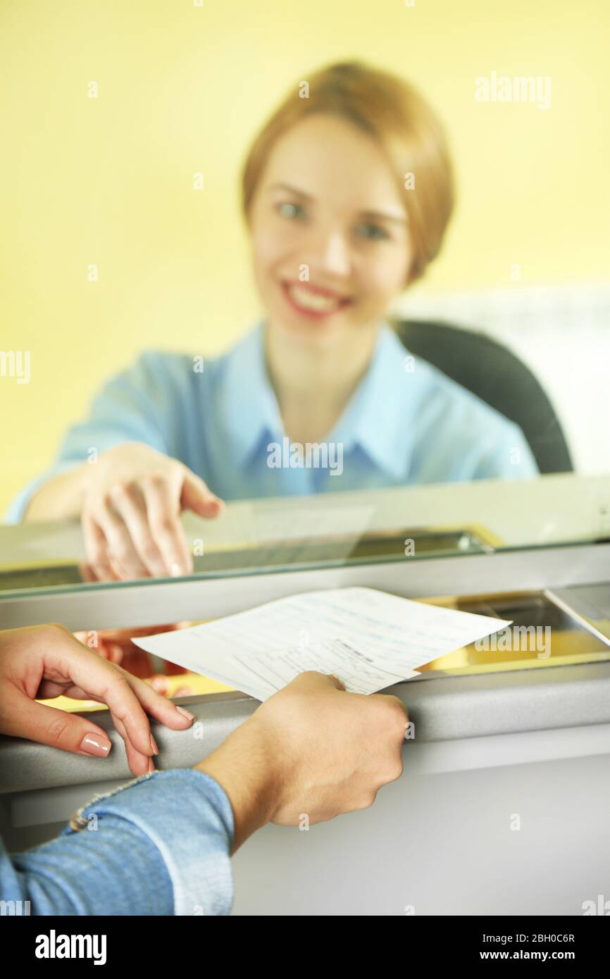 Teller window with working cashier. Concept of payment of utilities ...