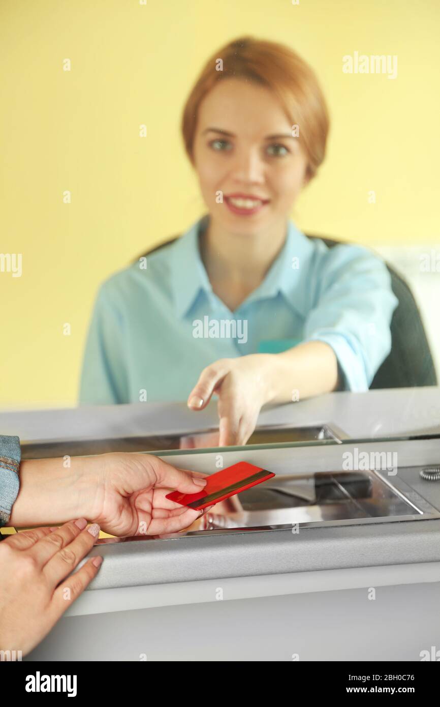 Teller window with working cashier Stock Photo - Alamy