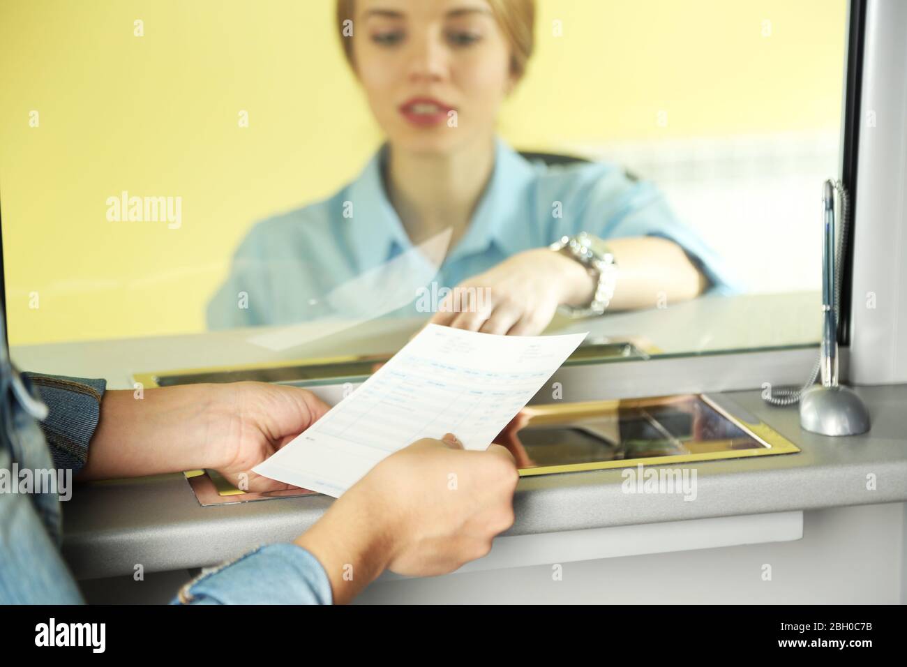 Teller window with working cashier. Concept of payment of utilities ...