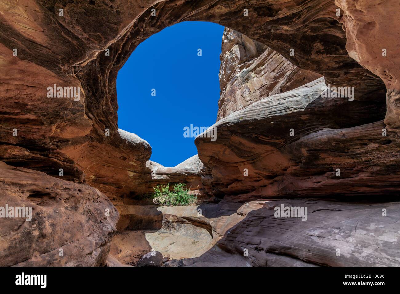 A natural red sandstone cave carved by water and wind on the Hickman ...