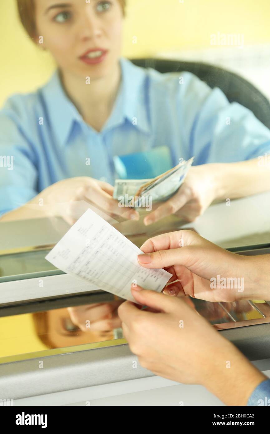 Teller window with working cashier Stock Photo - Alamy