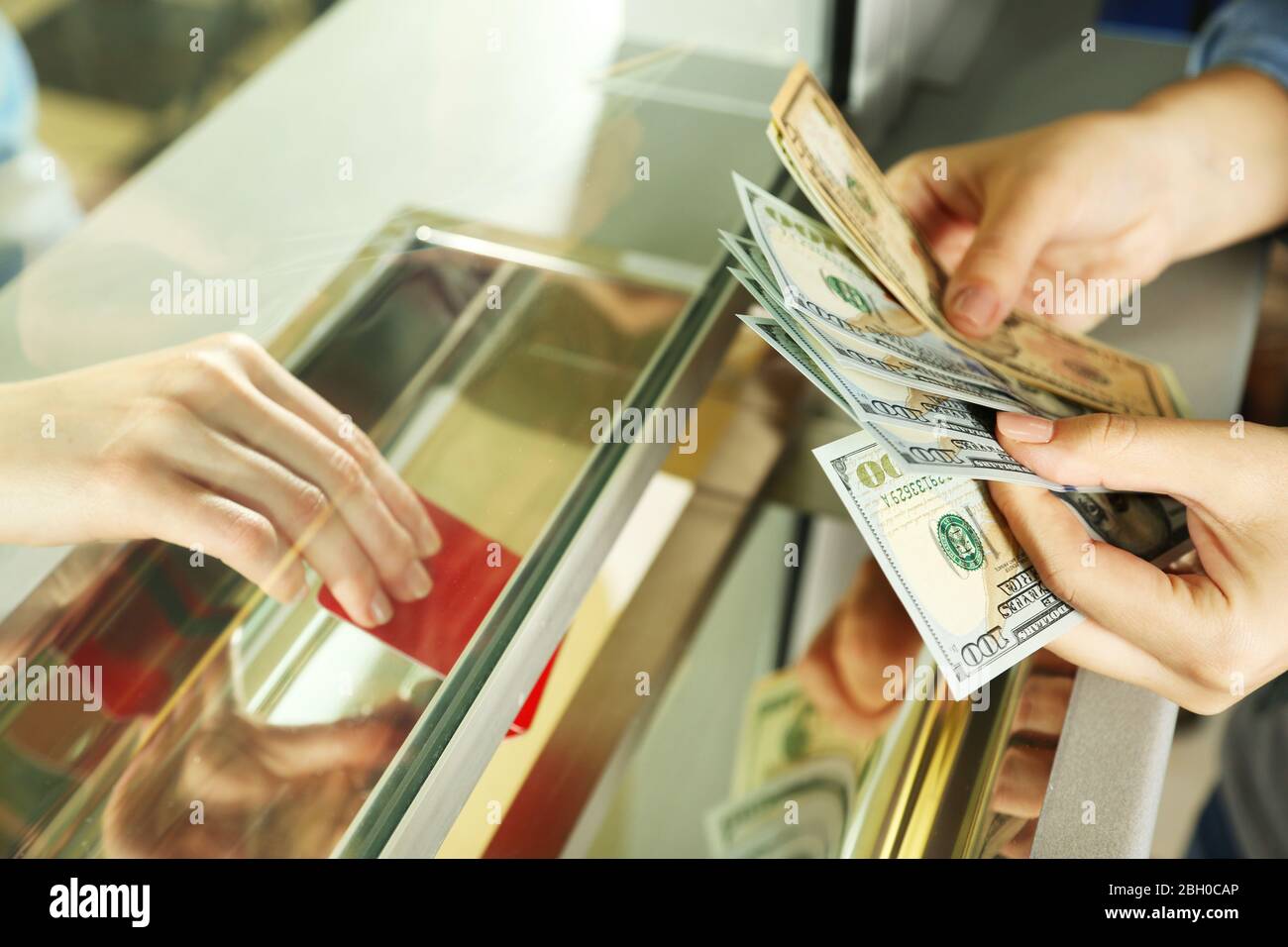 Female hand with money in cash department window. Currency exchange ...