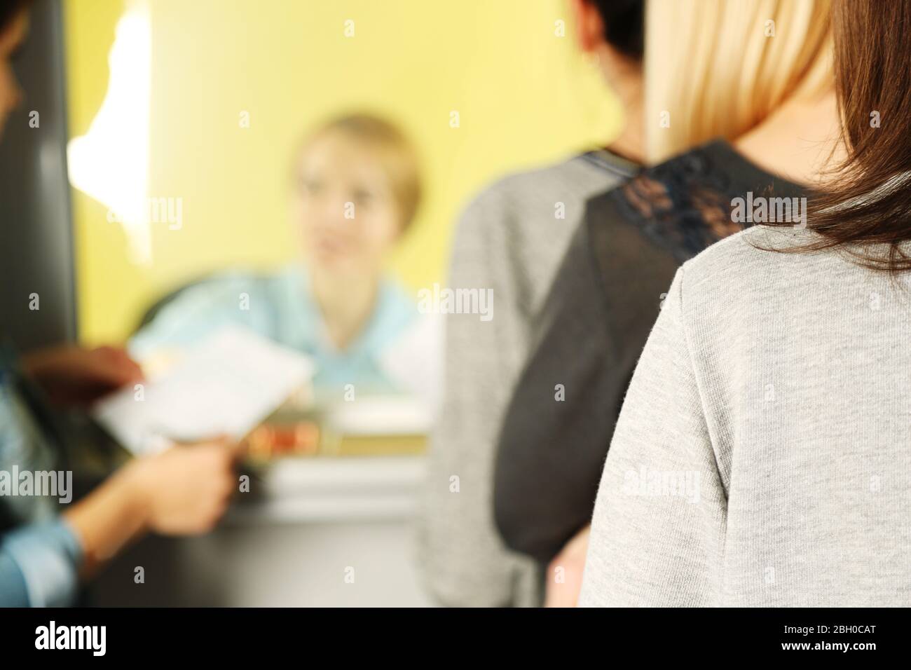 Teller window with working cashier Stock Photo - Alamy