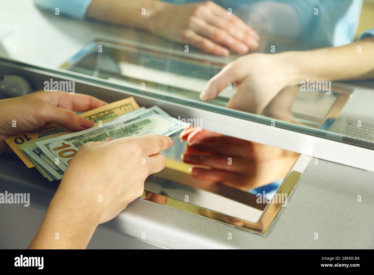 Female hand with money in cash department window. Currency exchange ...