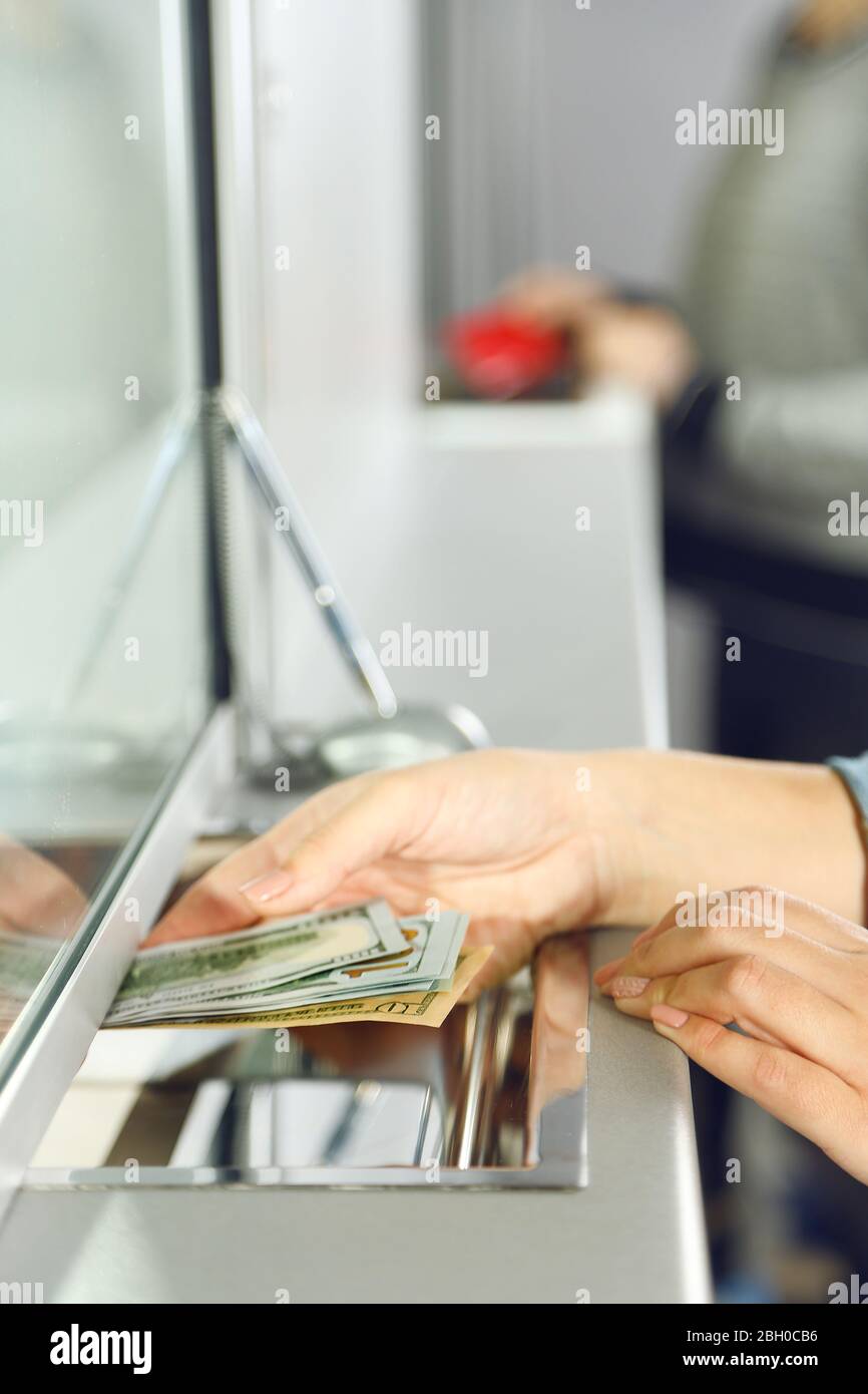 Female hand with money in cash department window. Currency exchange ...