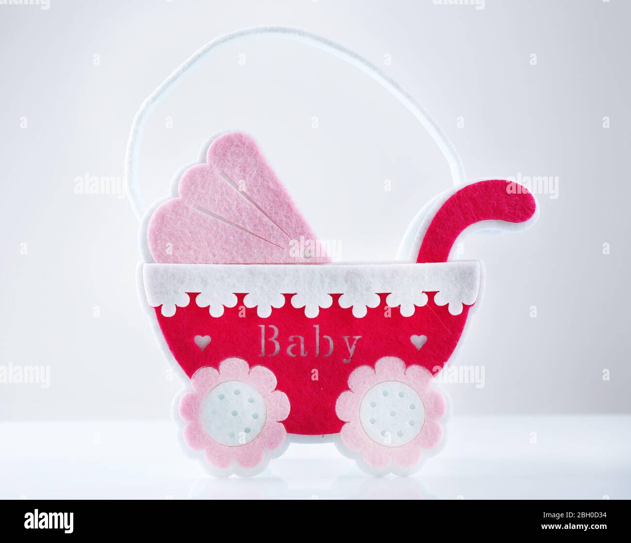 Pink little pram isolated on white Stock Photo - Alamy