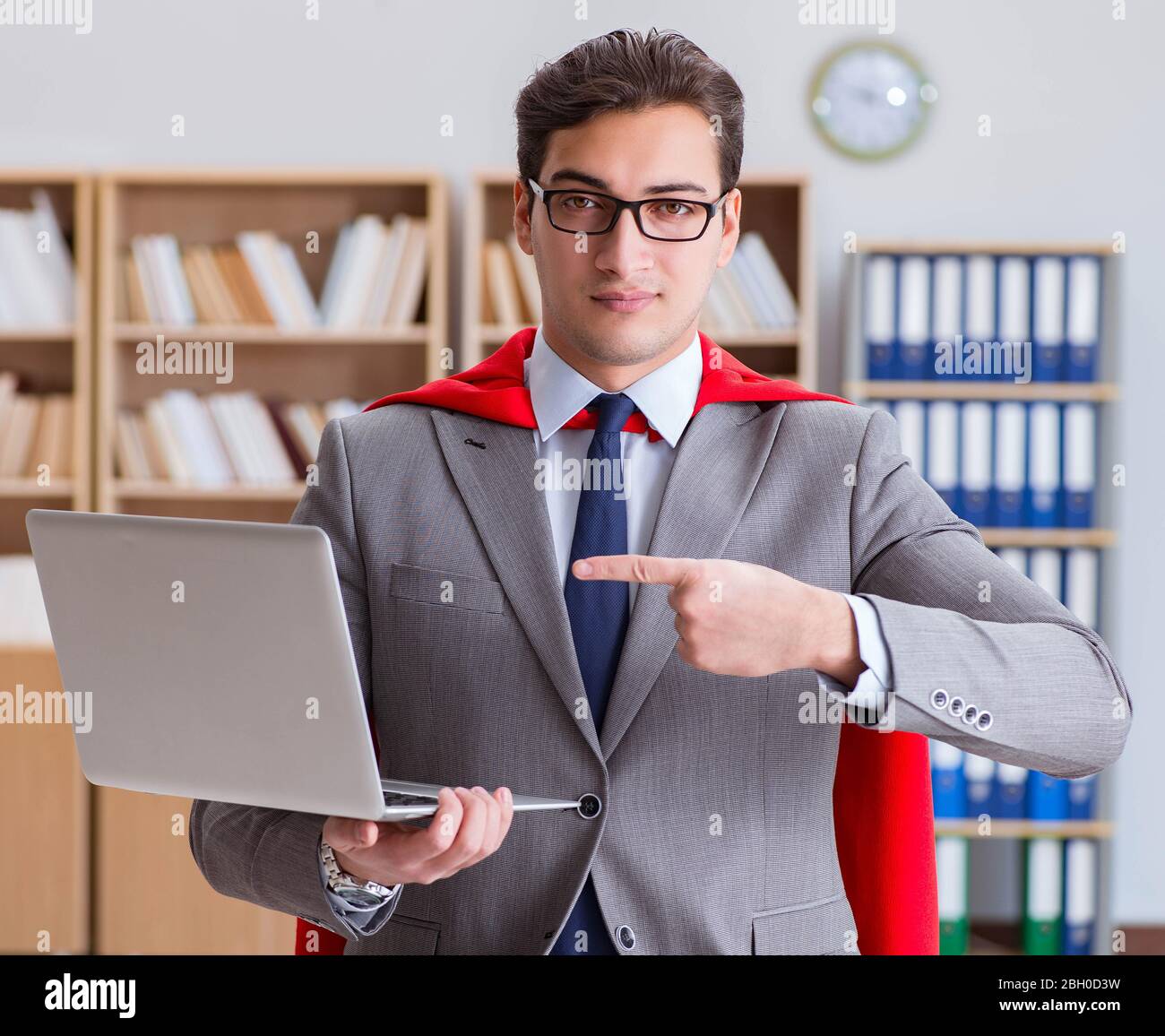 The superhero businessman working in the office Stock Photo - Alamy