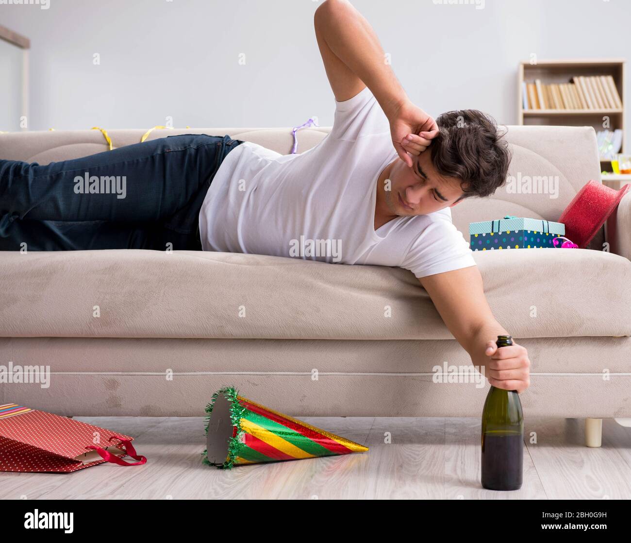 The man at home after heavy partying Stock Photo - Alamy