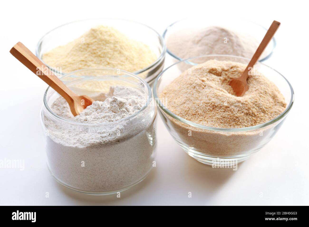 Different types of flour in bowls close up Stock Photo - Alamy
