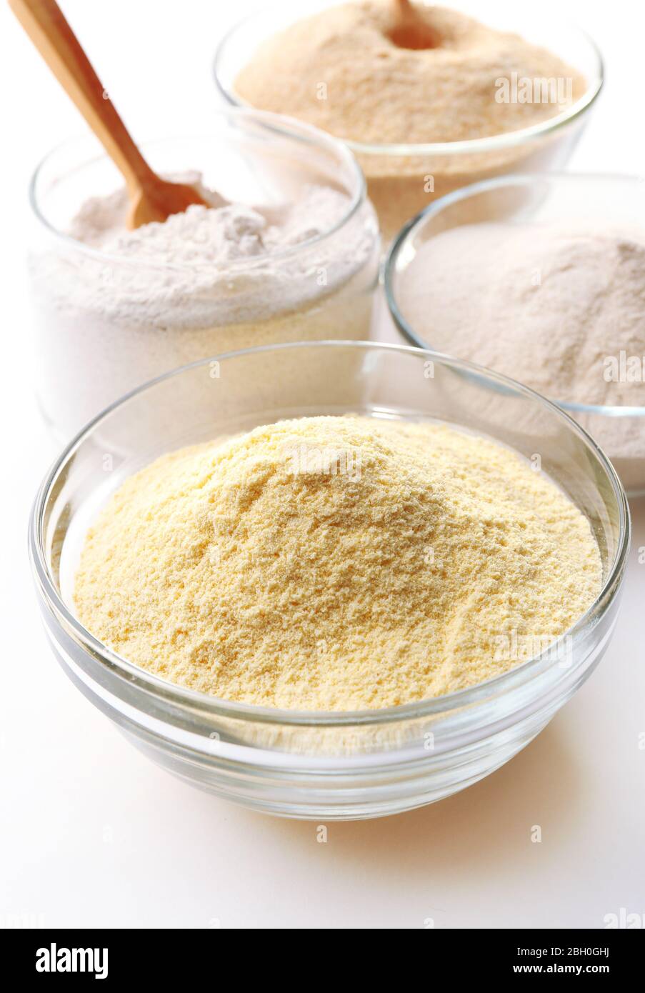 Different types of flour in bowls close up Stock Photo - Alamy