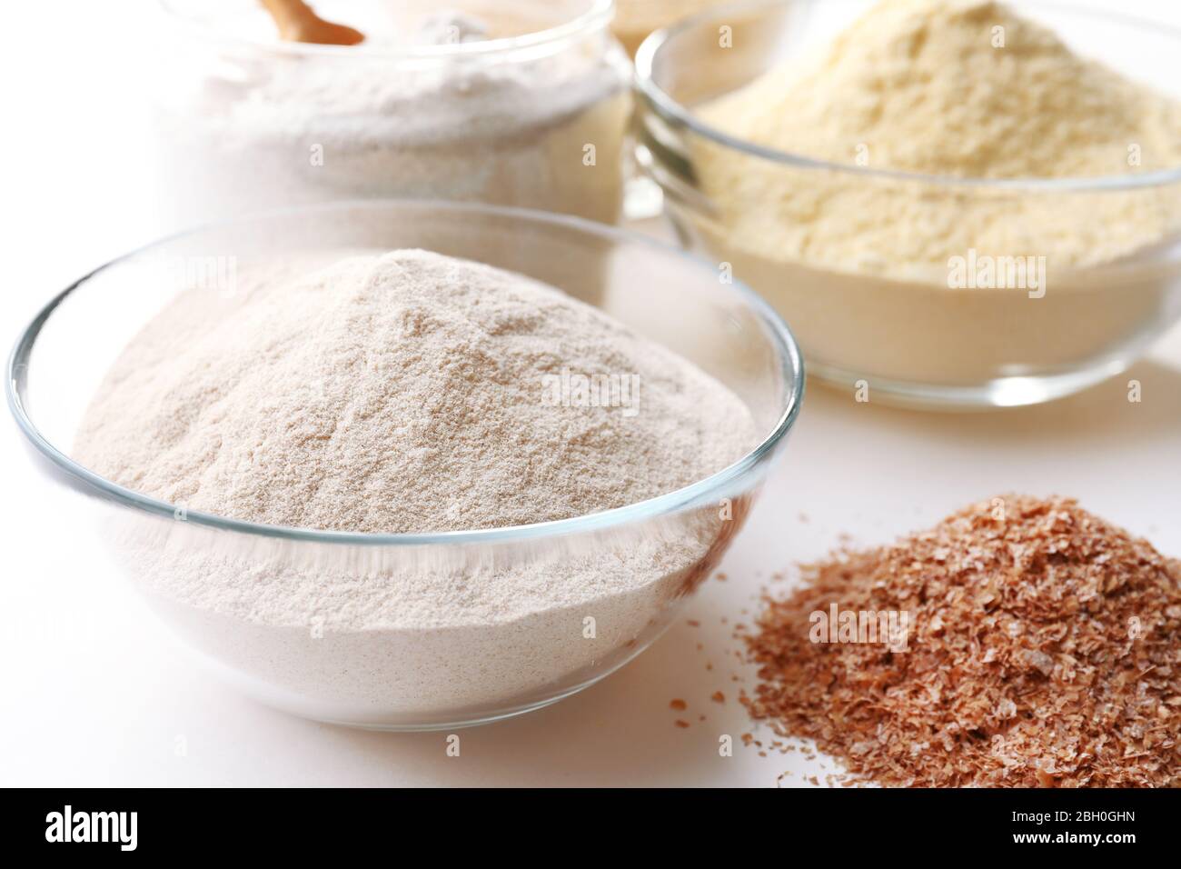 Different types of flour in bowls close up Stock Photo - Alamy