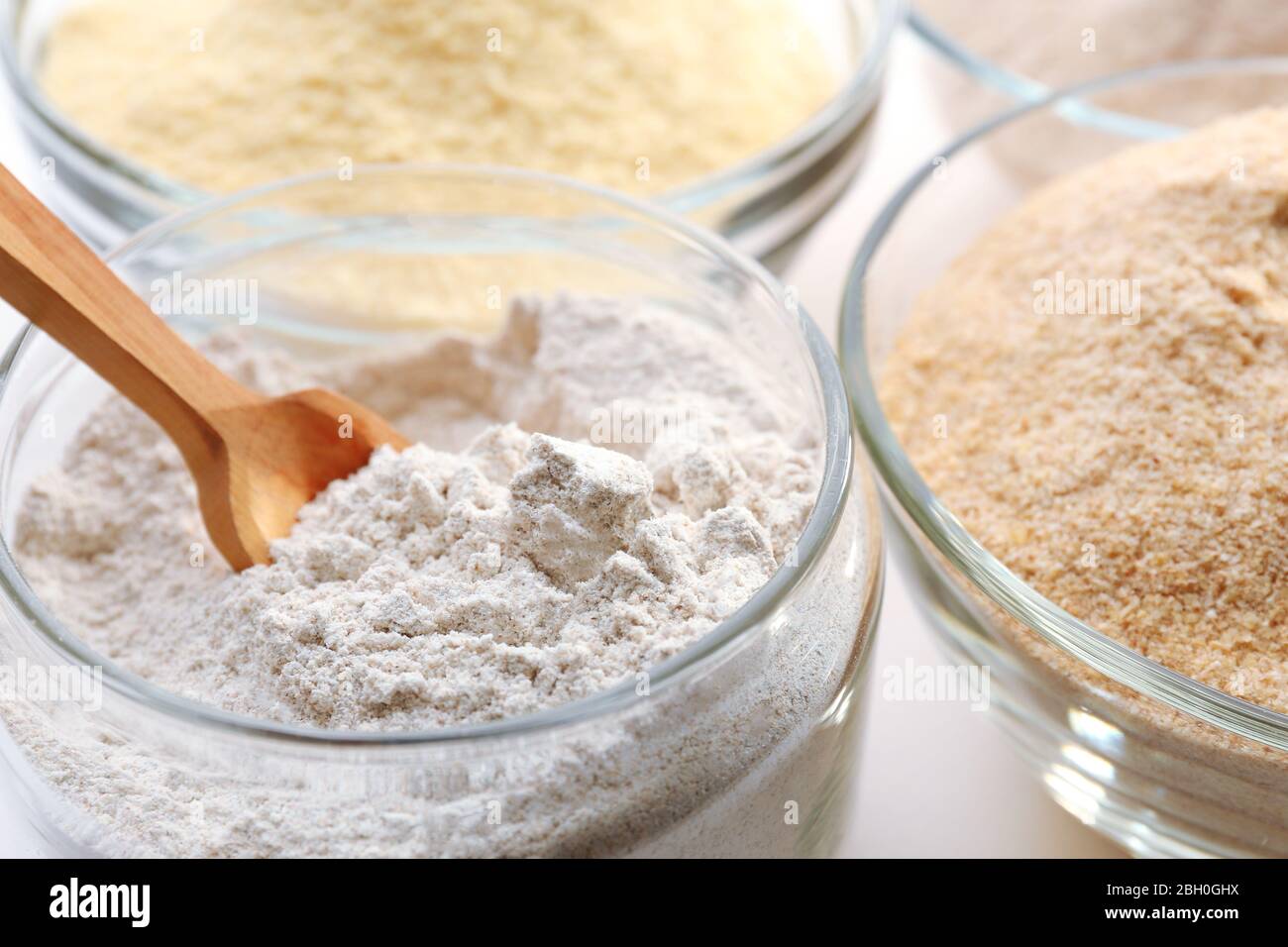 Different types of flour in bowls close up Stock Photo - Alamy