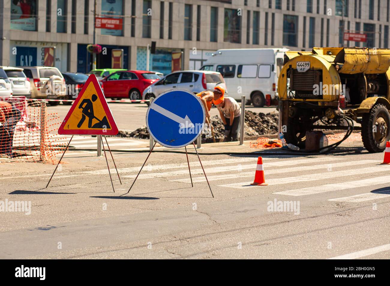 Road repair. Warning signs about repair work of a paving. Attention ...