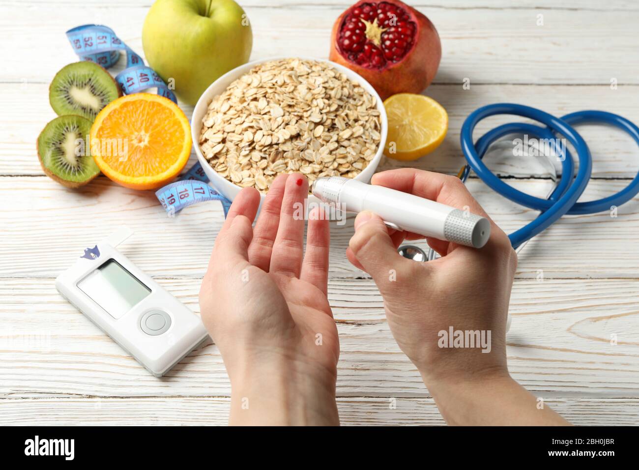 Female checking blood sugar level on background with diabetic ...