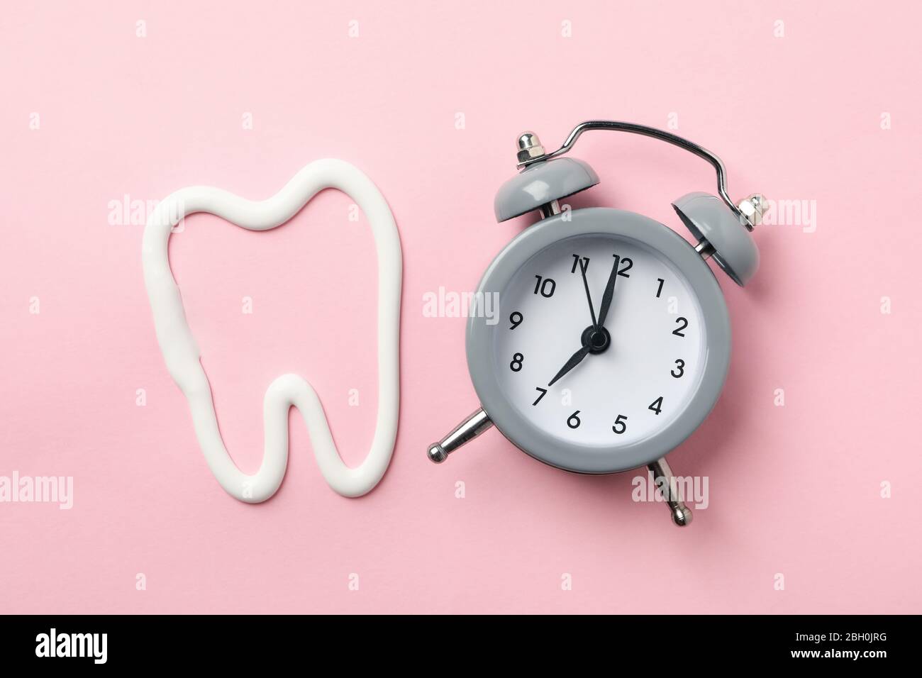 Tooth made of toothpaste and clock on pink background, top view Stock ...