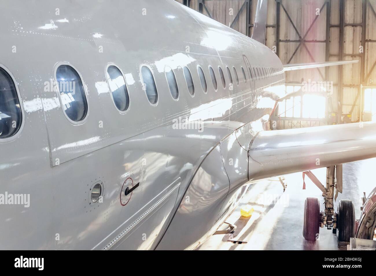 View of the fuselage of a passenger airliner with portholes and a wing ...