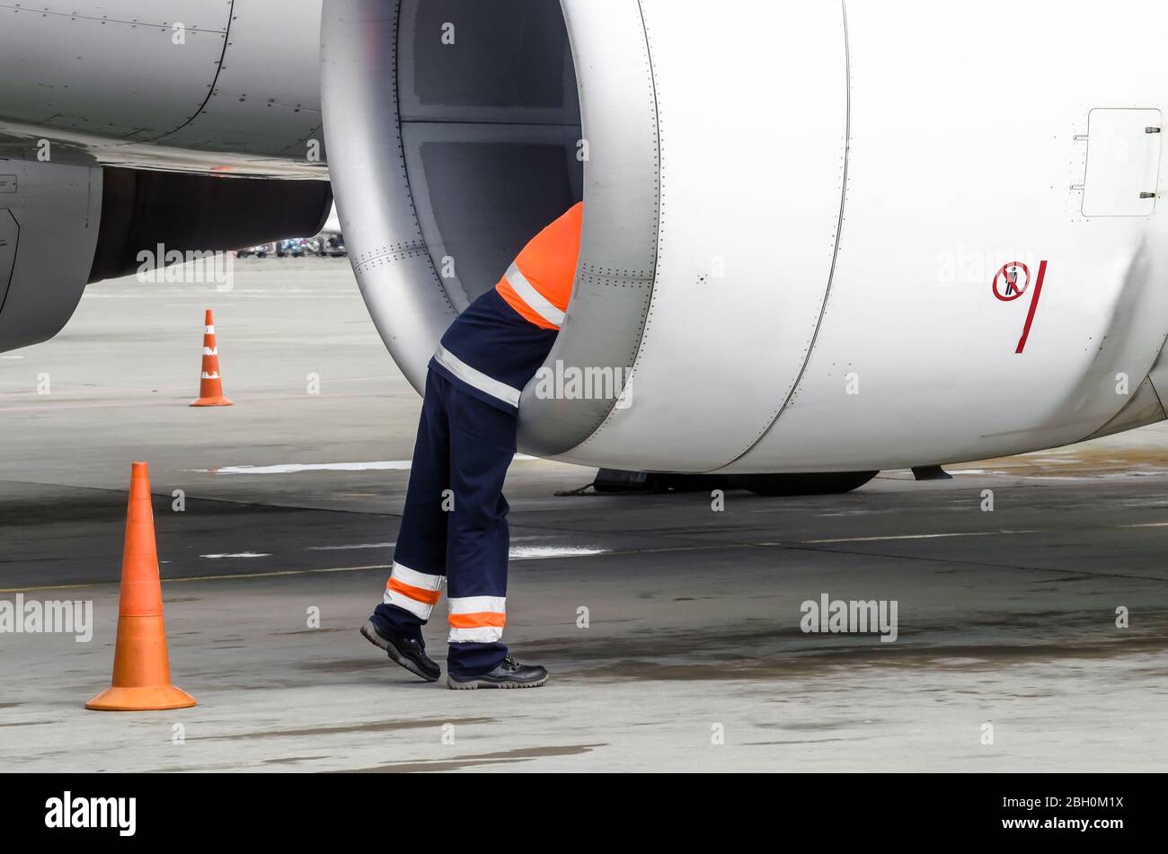 Human technician engineer checks the turbine engine's airplane blade ...