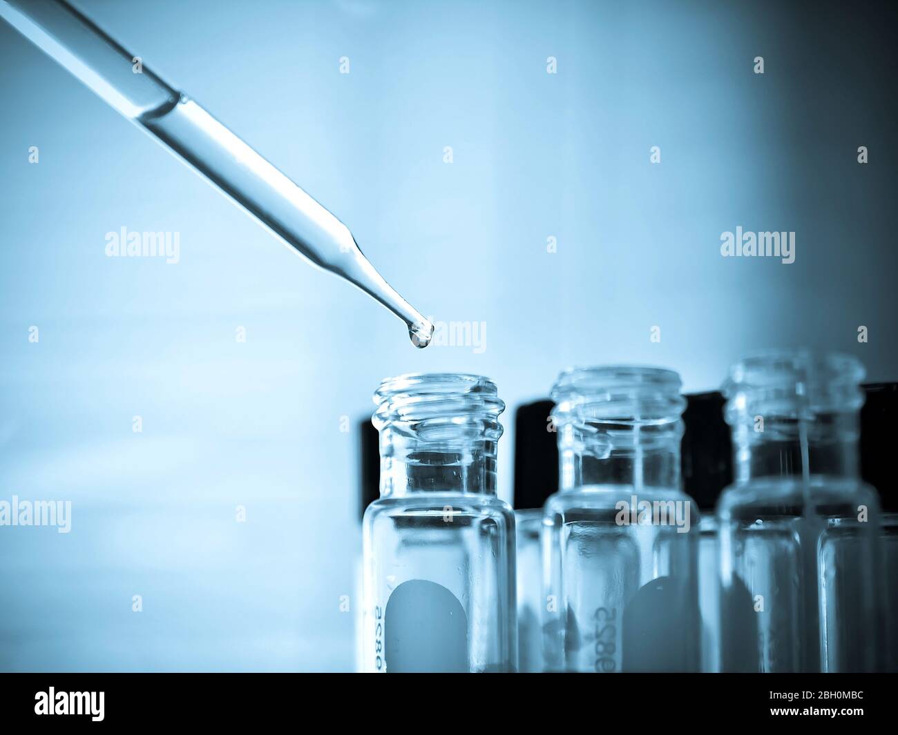 Dropping chemical liquid to test tube, laboratory research and ...