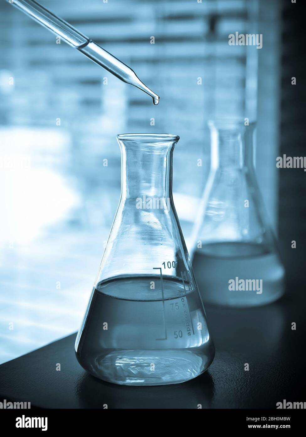Dropping chemical liquid to test tube, laboratory research and ...