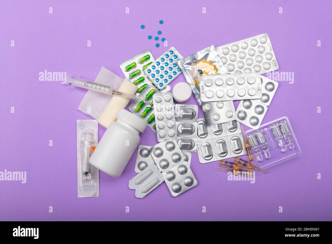 Different medicines on a lilac background. Colored and different types ...