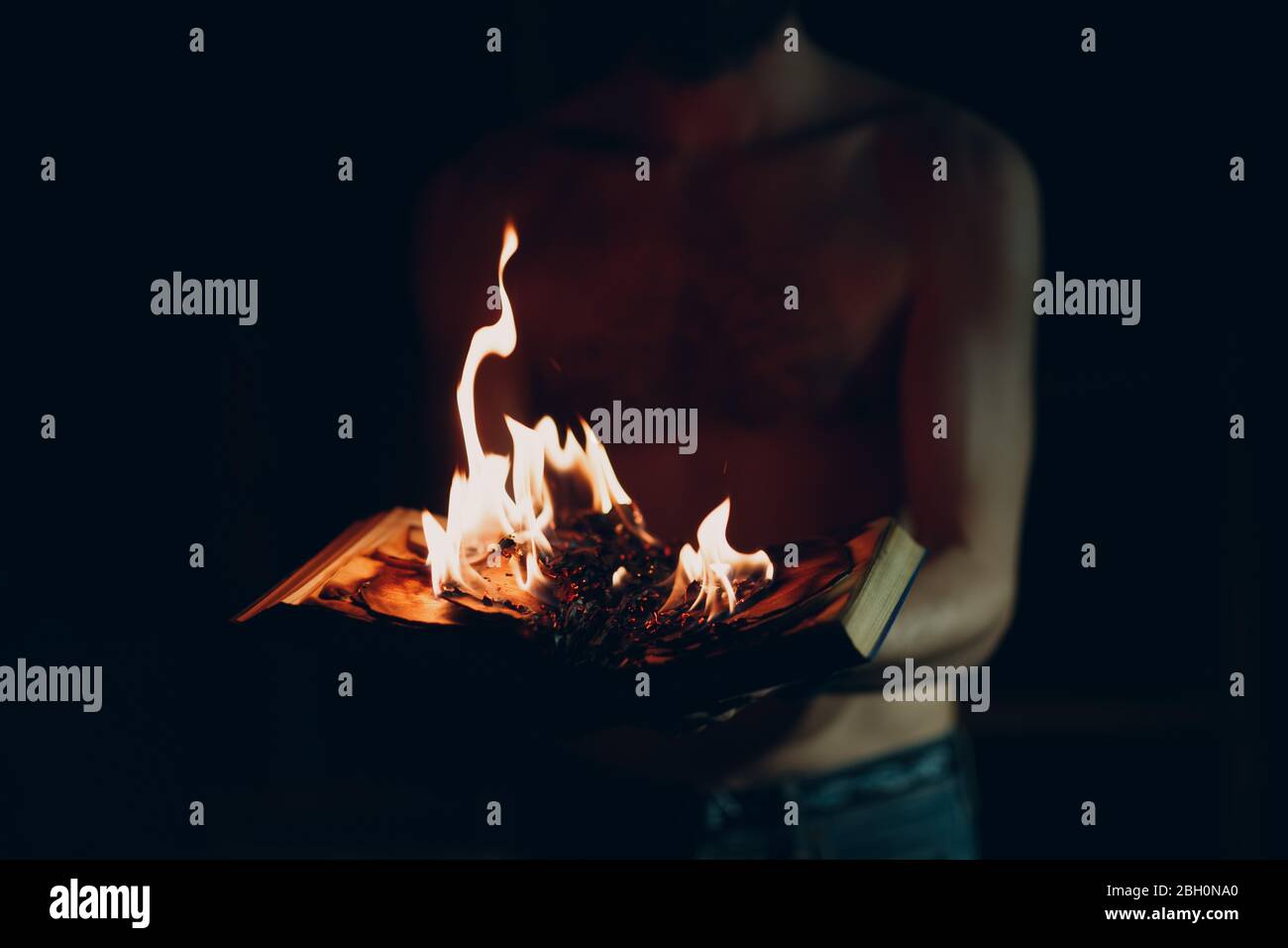 Book burns on dark background Stock Photo - Alamy