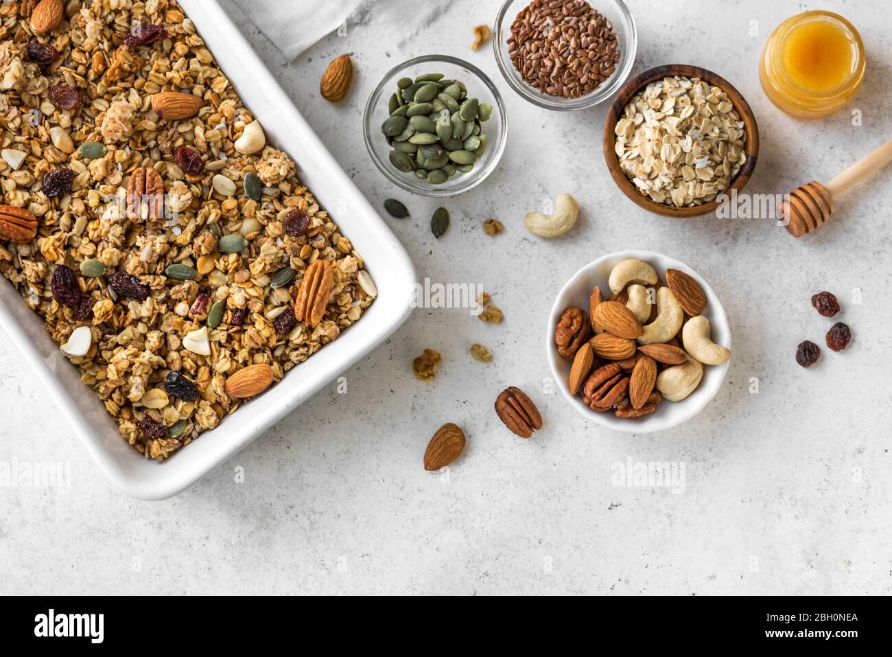 Roasted Granola with ingredients - nuts, raisins, honey and seeds ...