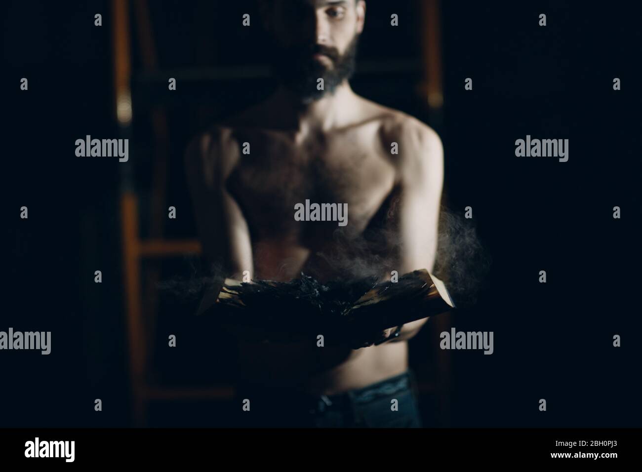 Man holds burning book in his hands Stock Photo - Alamy