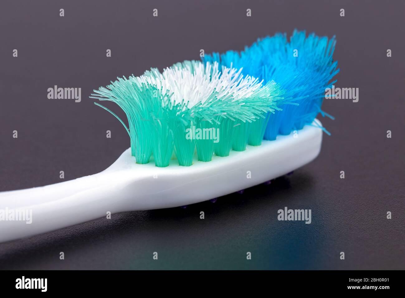 Old unusable worn-out and must change close up toothbrush on black ...