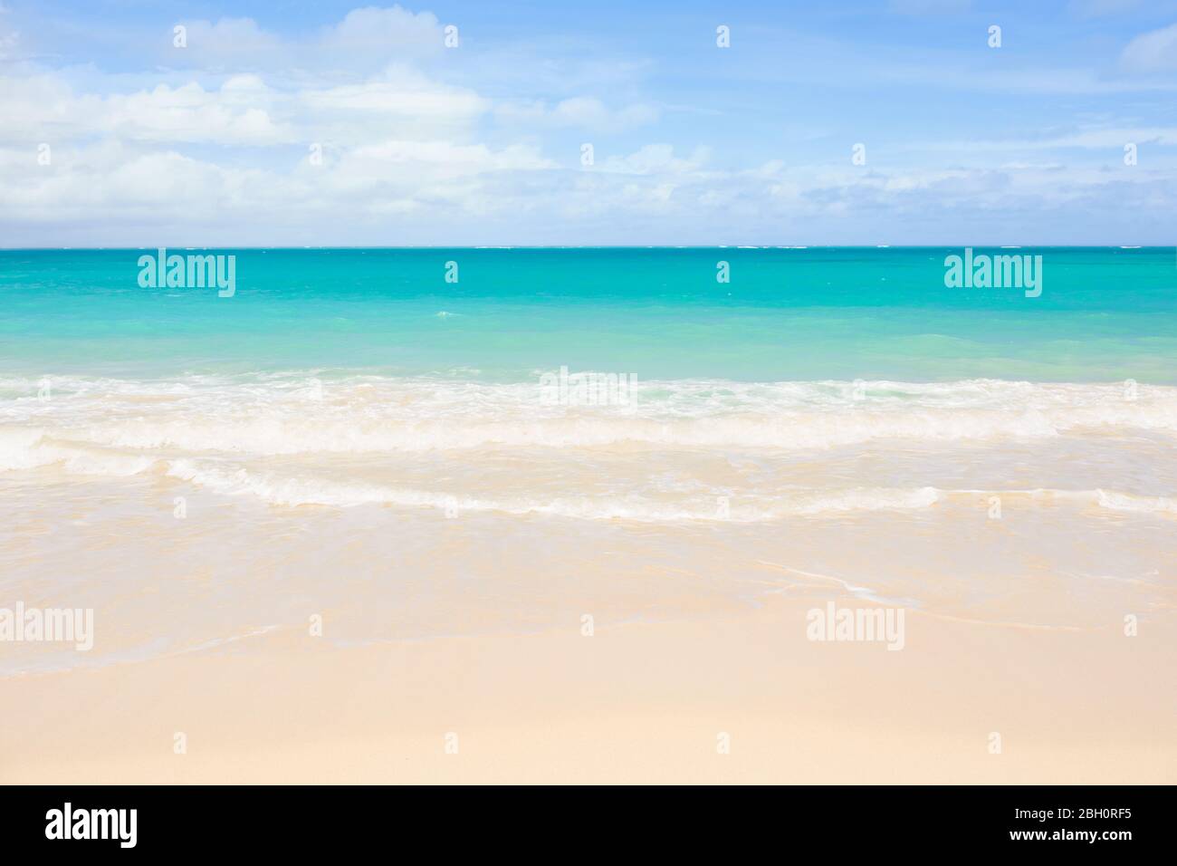Beautiful clear blue aqua ocean waves with seafoam on warm sandy beach ...