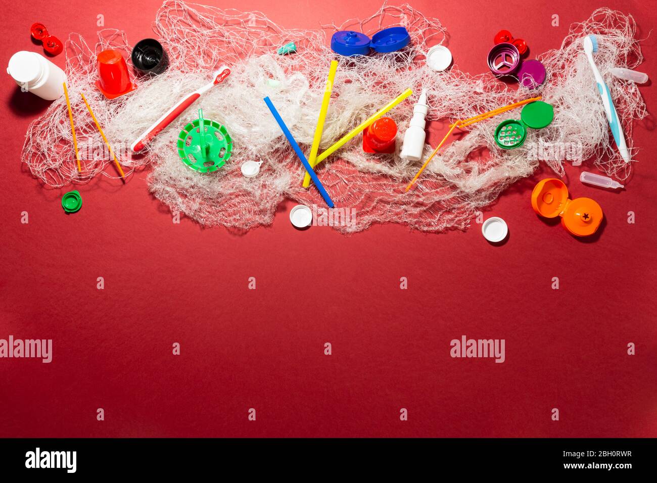 Assortment of obsolete plastic garbage items on colorful background ...