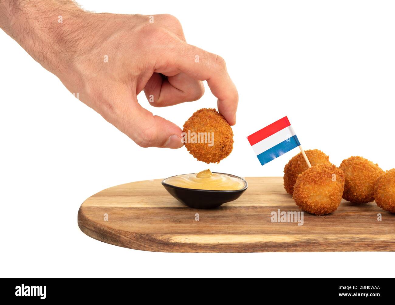 Dutch traditional snack bitterbal in a hand, isolated Stock Photo - Alamy