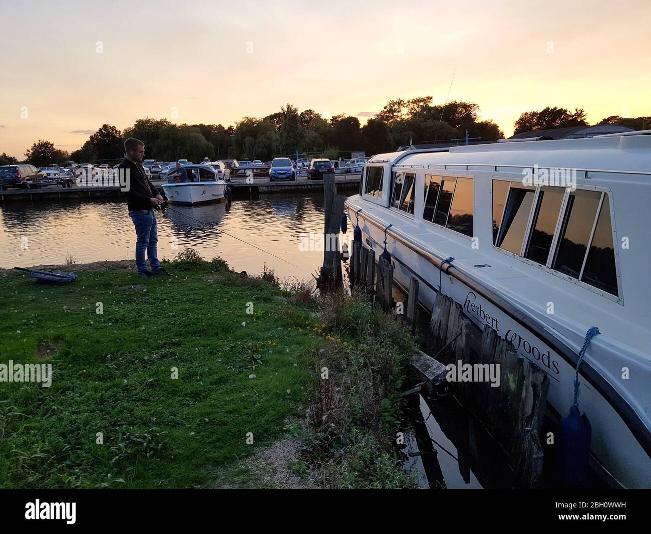 Man fishing for Pike while on a Norfolk broads boating holiday Stock ...