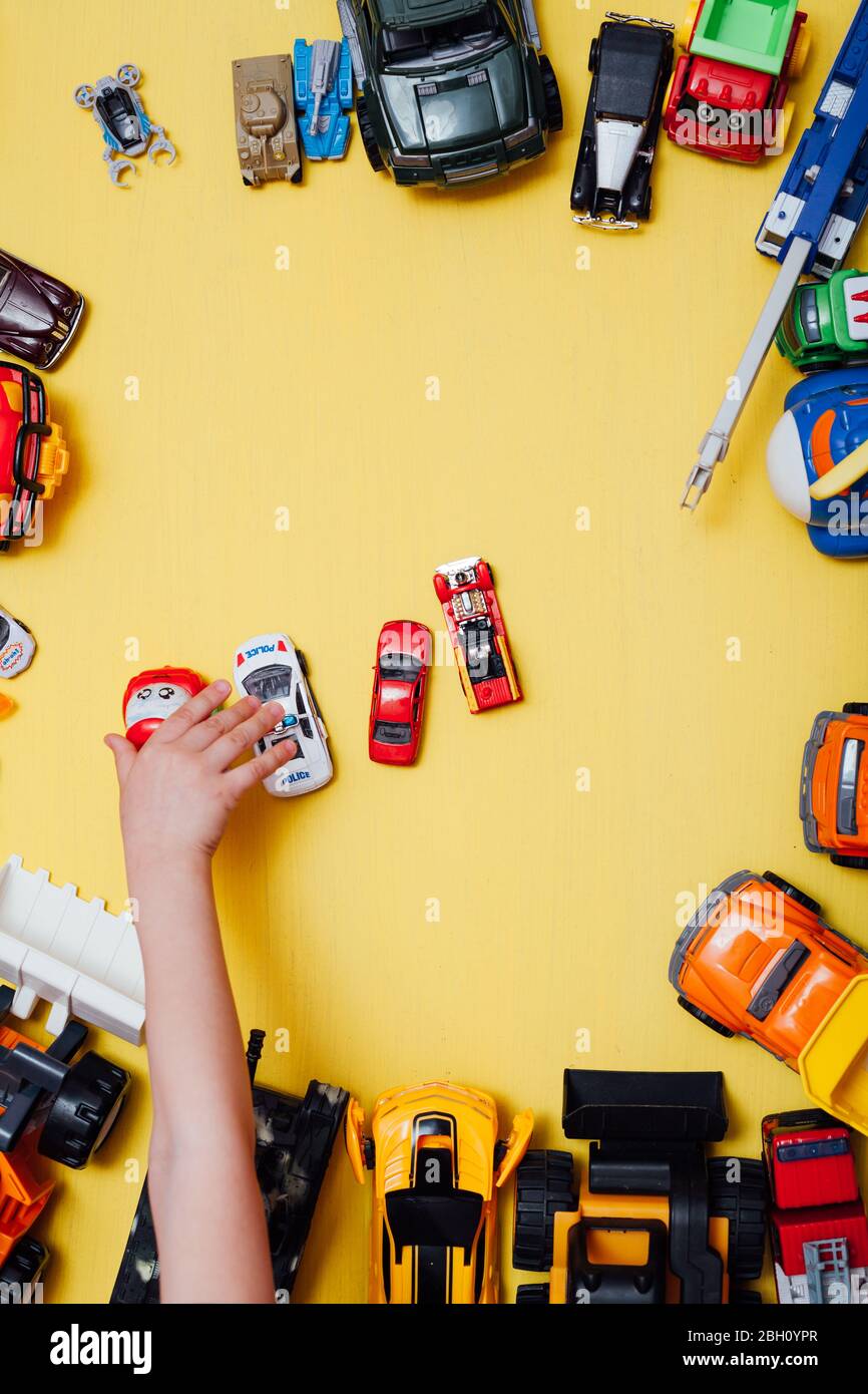 lots of children's toy machines for playing boy on a yellow background ...