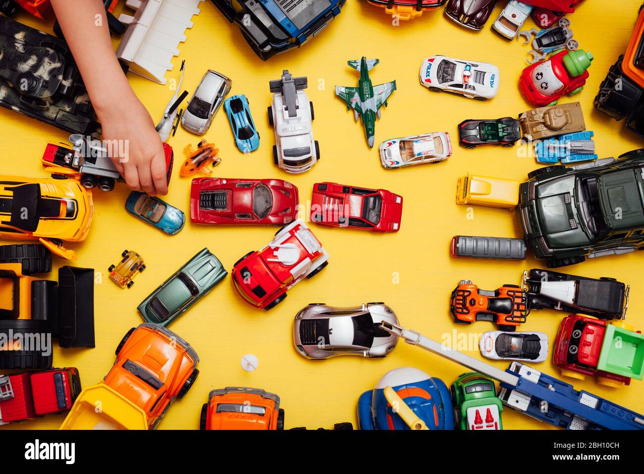lots of children's toy machines for playing boy on a yellow background ...
