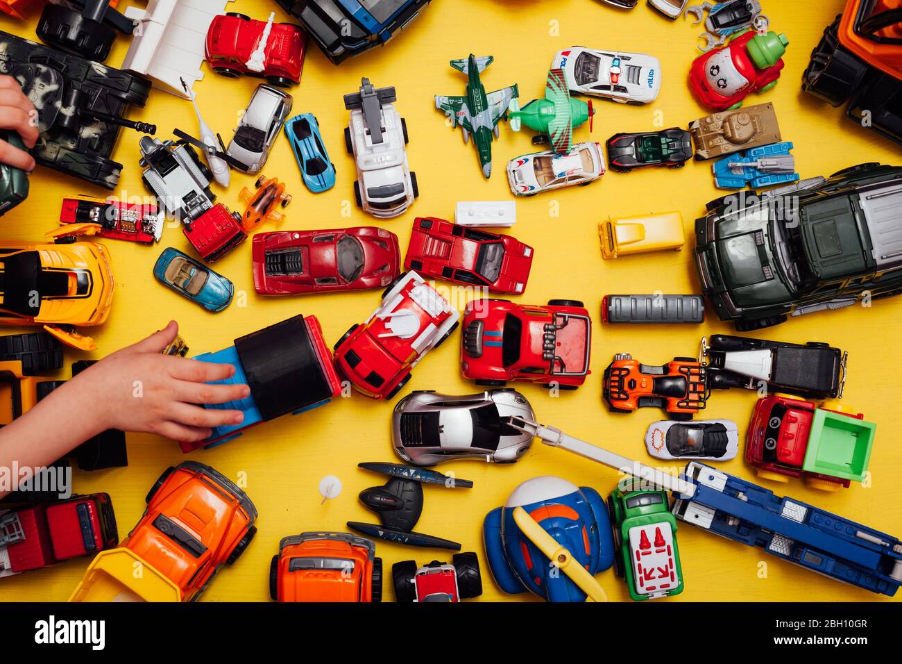 lots of children's toy machines for playing boy on a yellow background ...