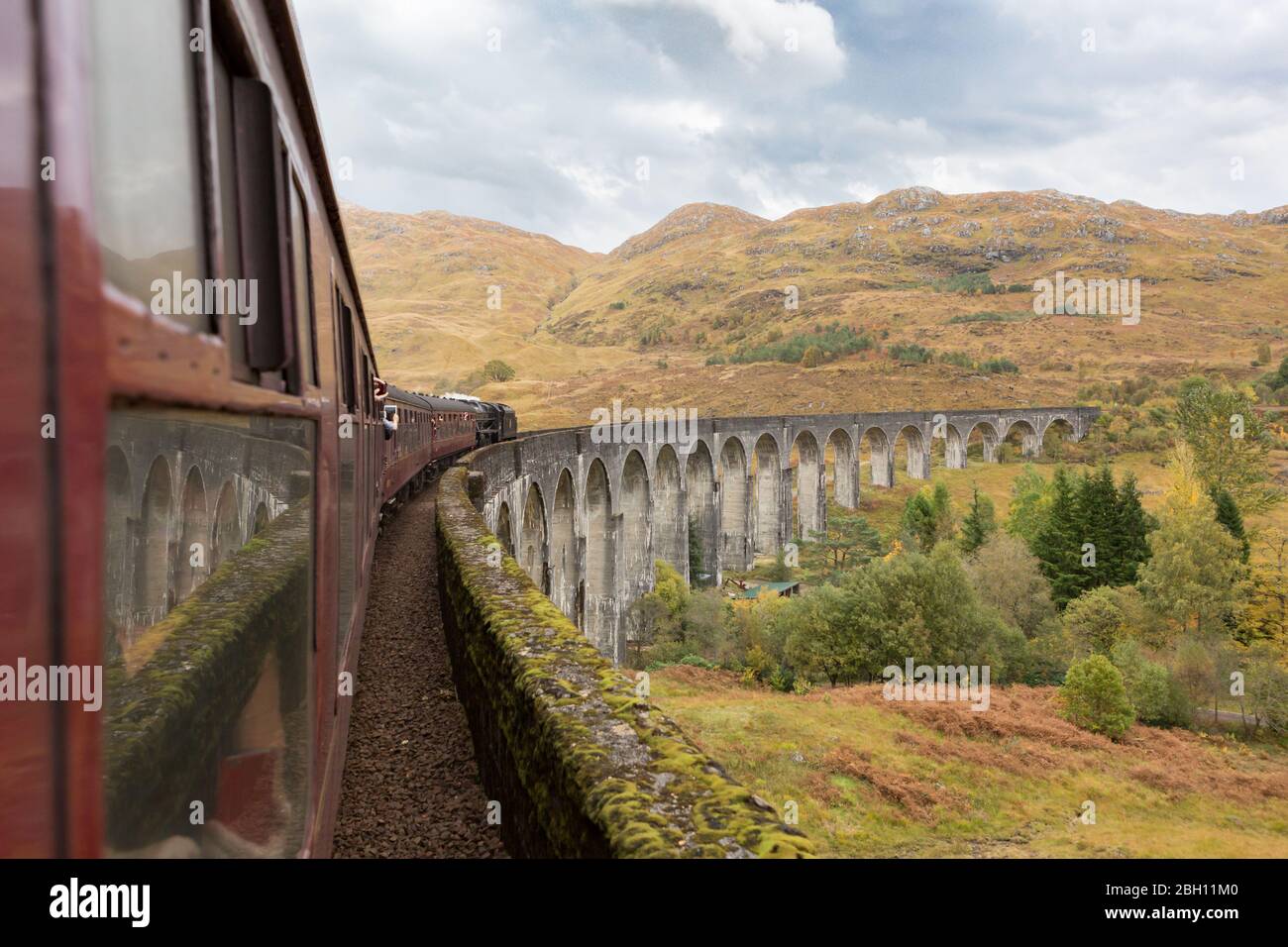 Jacobite steam train crossing the Glenfinnan viaduct in the Highlands ...