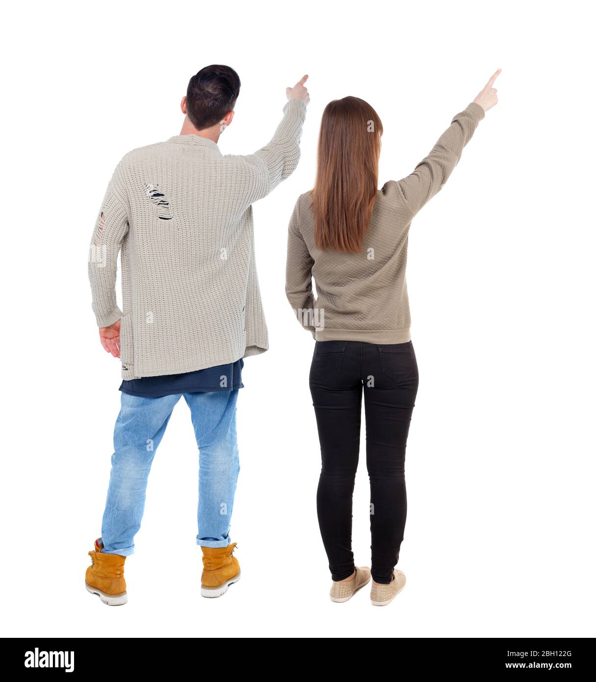 Back view of couple in sweater pointing. Rear view people collection ...