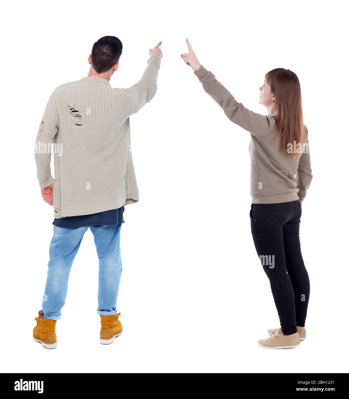 Back view of couple in sweater pointing. Rear view people collection ...