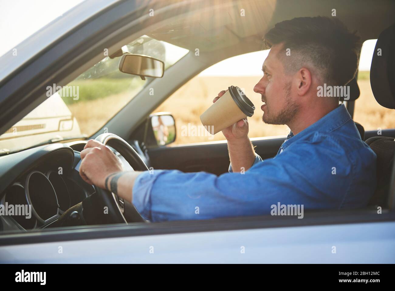 Man drinking coffee driving car hi-res stock photography and images - Alamy