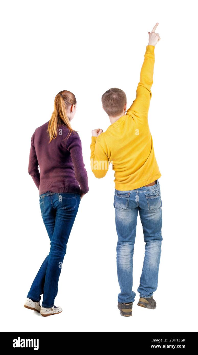 Back view of couple in sweater pointing. Rear view people collection ...