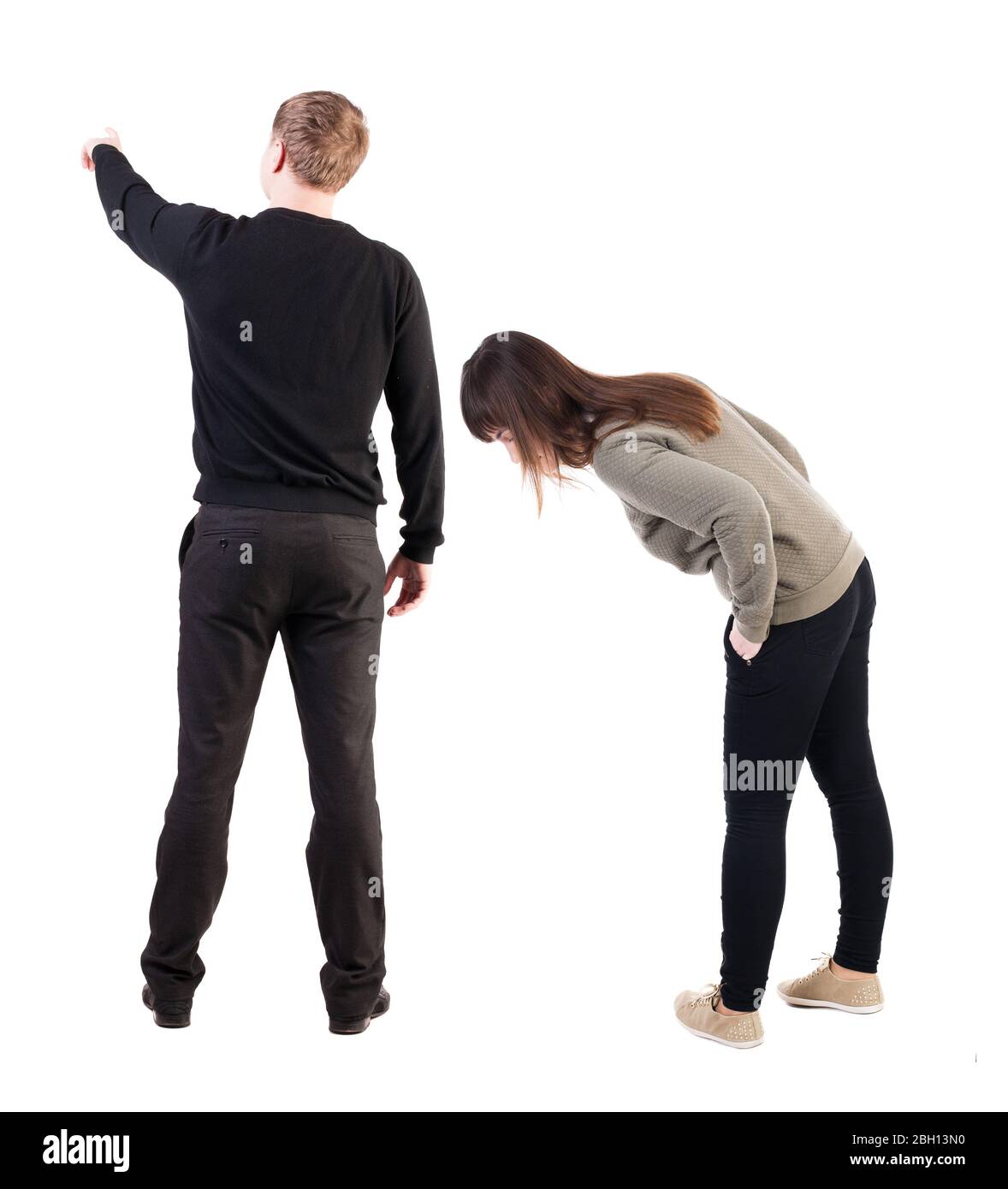 Back view of couple in sweater pointing. Rear view people collection ...