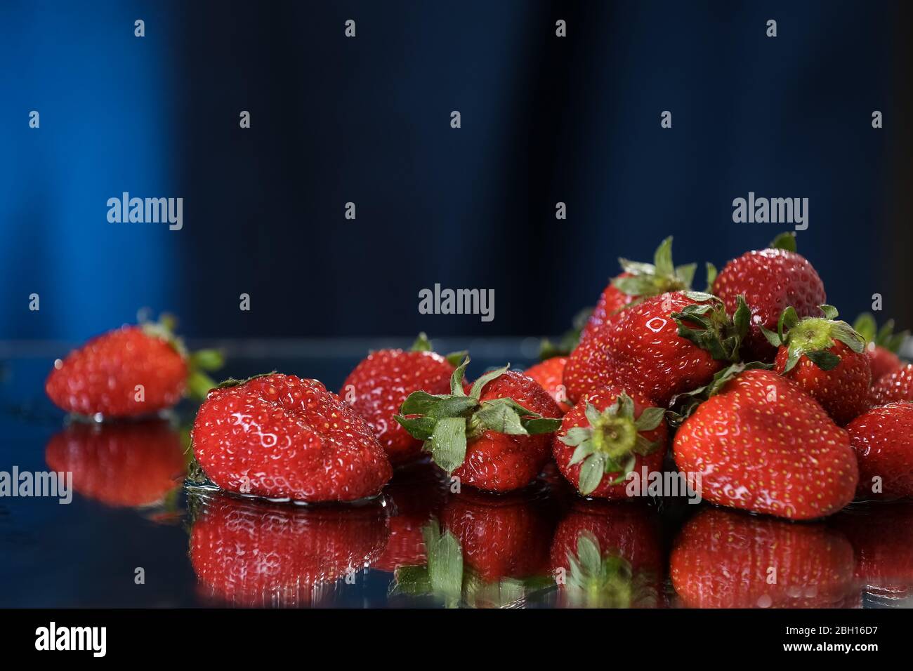 strawberries closeup on a dark blue background. Healthy lifestyle ...