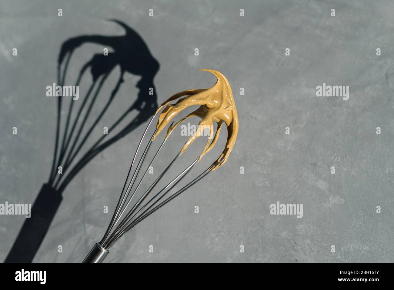 Whipping instant coffee for dalgona drink with whisk. Hard sun light ...