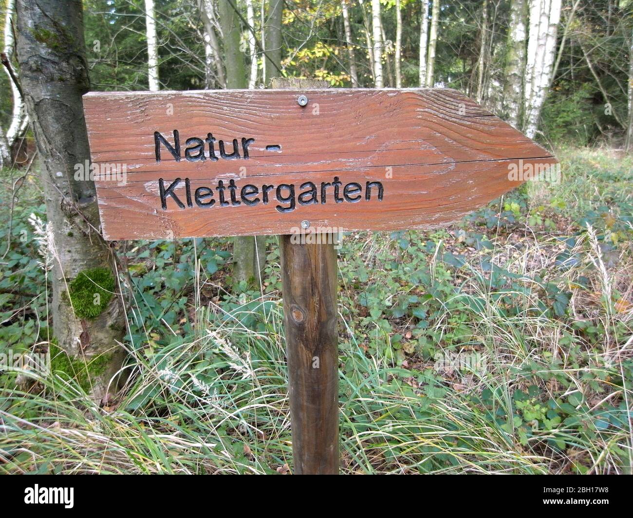 guidepost in a forest to the nature climbing park, Germany Stock Photo ...