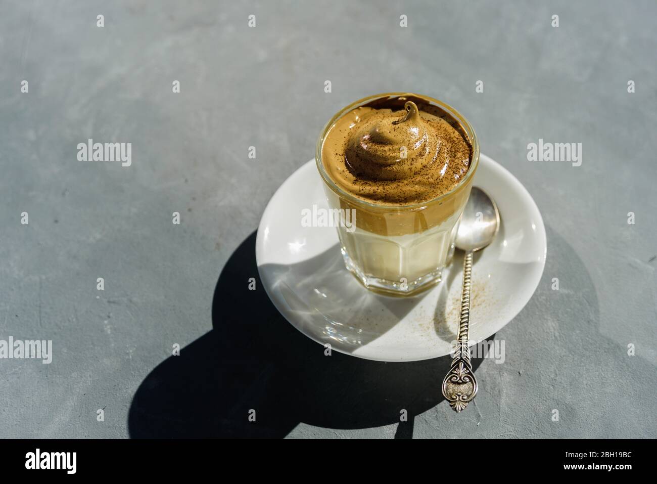 Dalgona instant coffee whipped drink with chocolate powder on top in ...