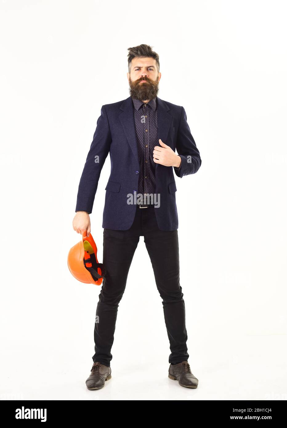 Engineer wears construction helmet. Engineer with long beard and ...