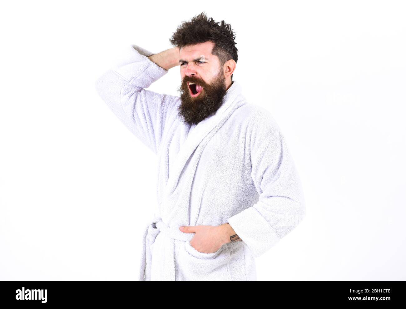 Man with beard and mustache yawning while scratching, itching head ...