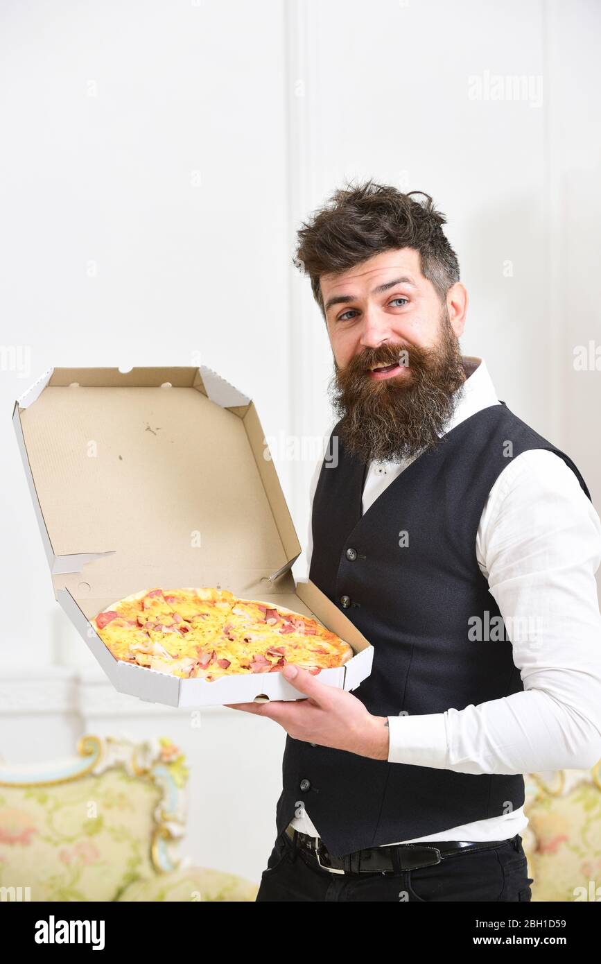 Pizza delivery concept. Man with beard and mustache holds delivered box ...